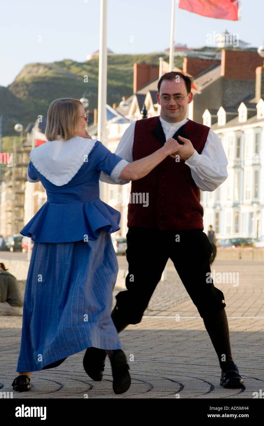 man and woman couple traditional welsh folk dancing on the promenade ...