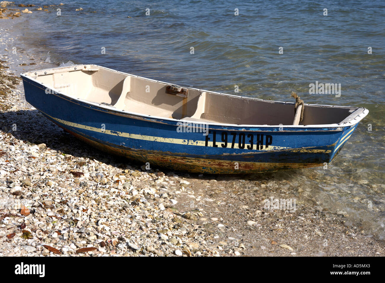 small wooden boat shoreline of island park with the skyline of sarasota ...