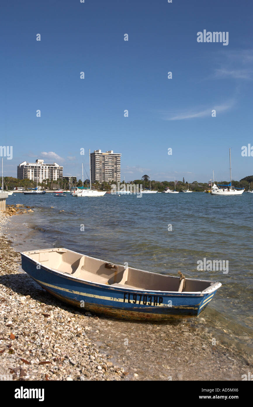 small wooden boat shoreline of island park with the skyline of sarasota ...