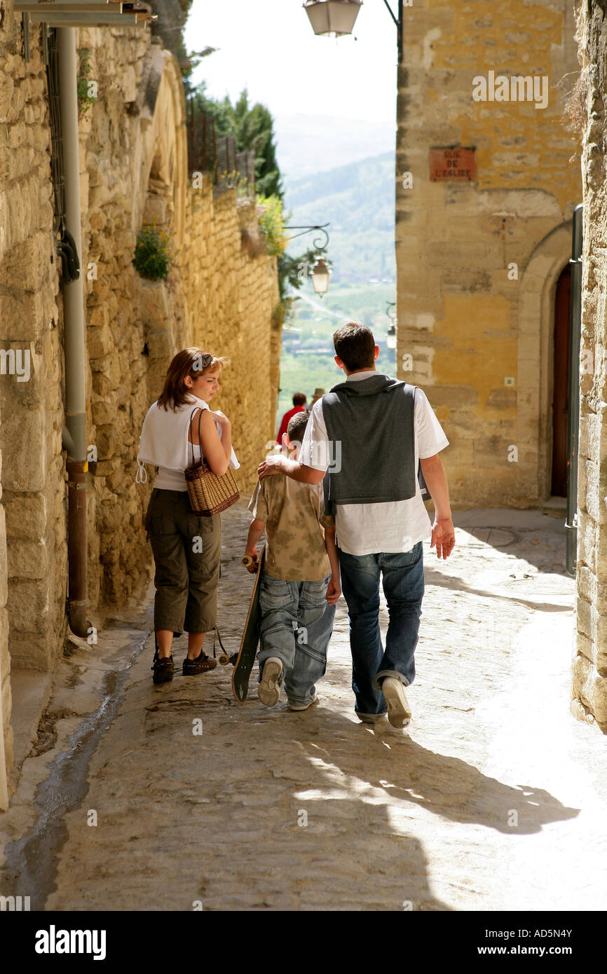 Family having a walk in a village Stock Photo - Alamy