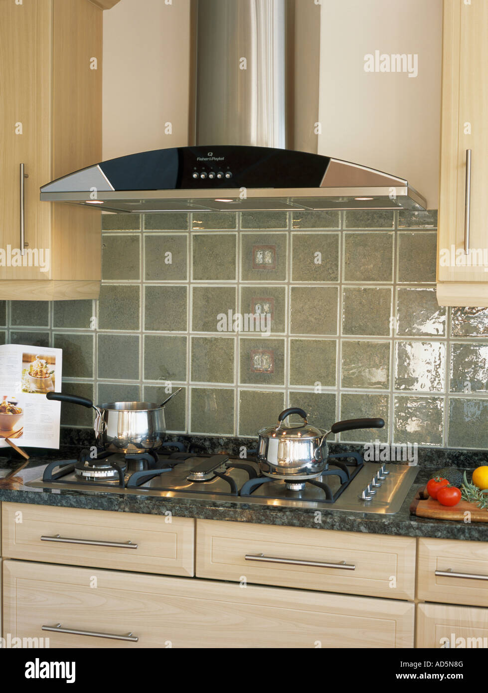 Tiled wall behind saucepans on gas hob in modern kitchen Stock Photo ...