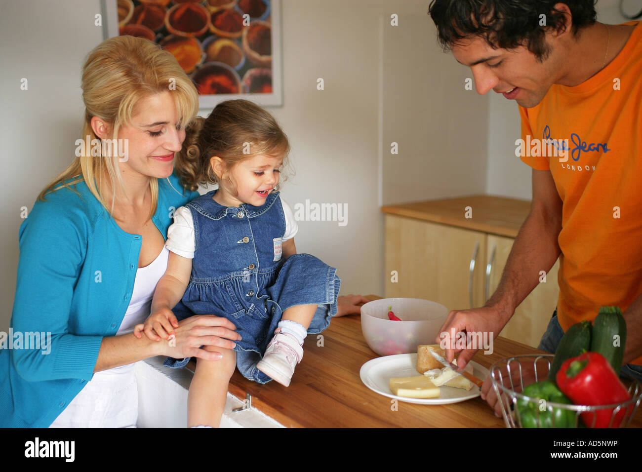 Parents and daughter having a snack Stock Photo - Alamy