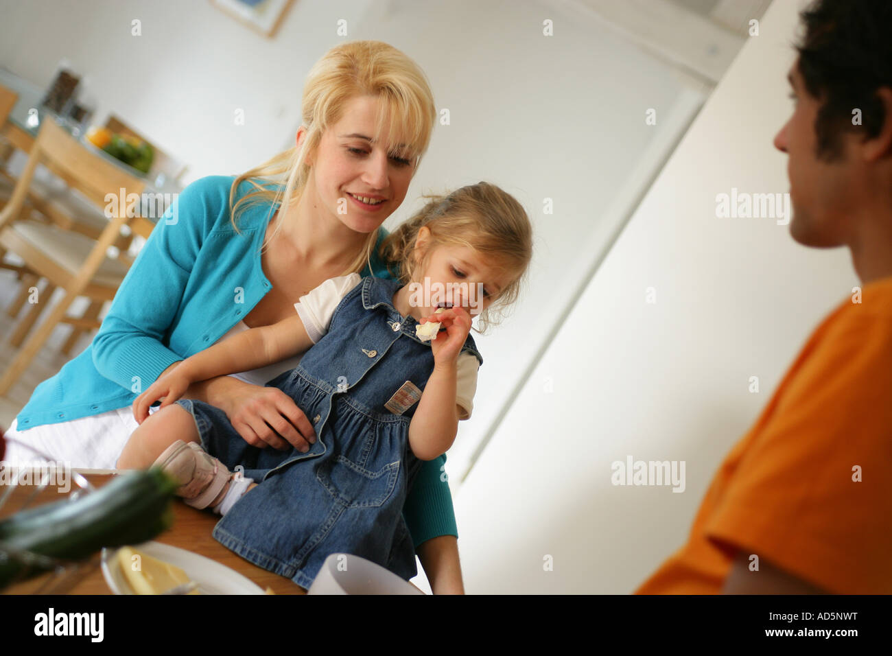 Parents and daughter having a snack Stock Photo - Alamy