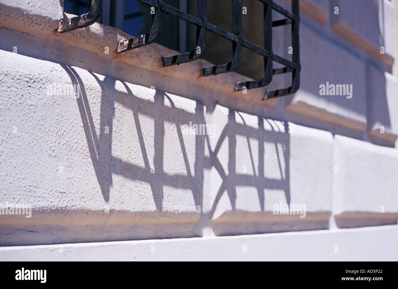 The shadow of a window grill on a white washed wall in Albarracin Spain ...