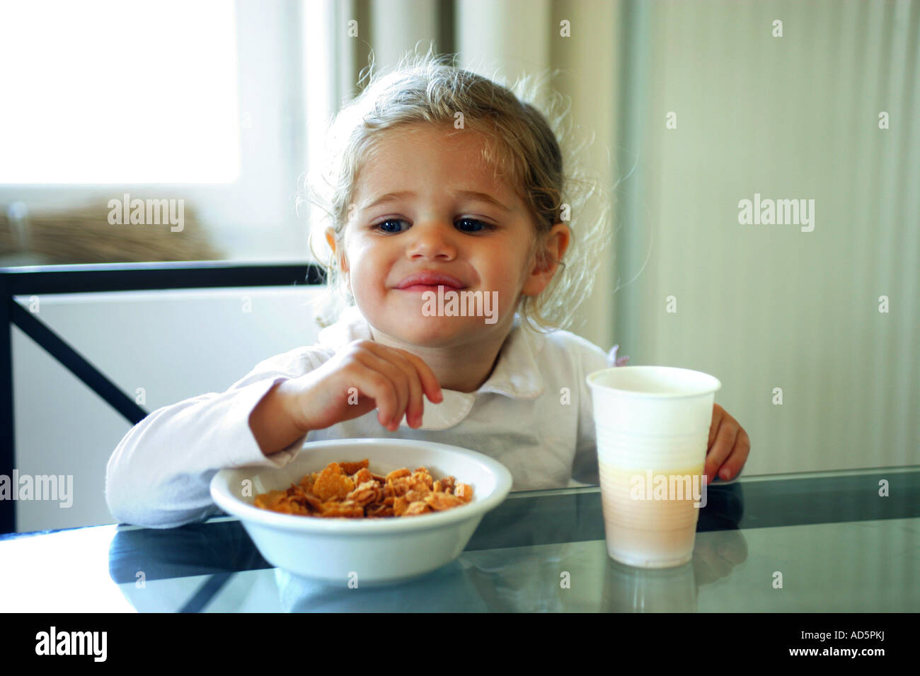 Little girl having a snack Stock Photo - Alamy
