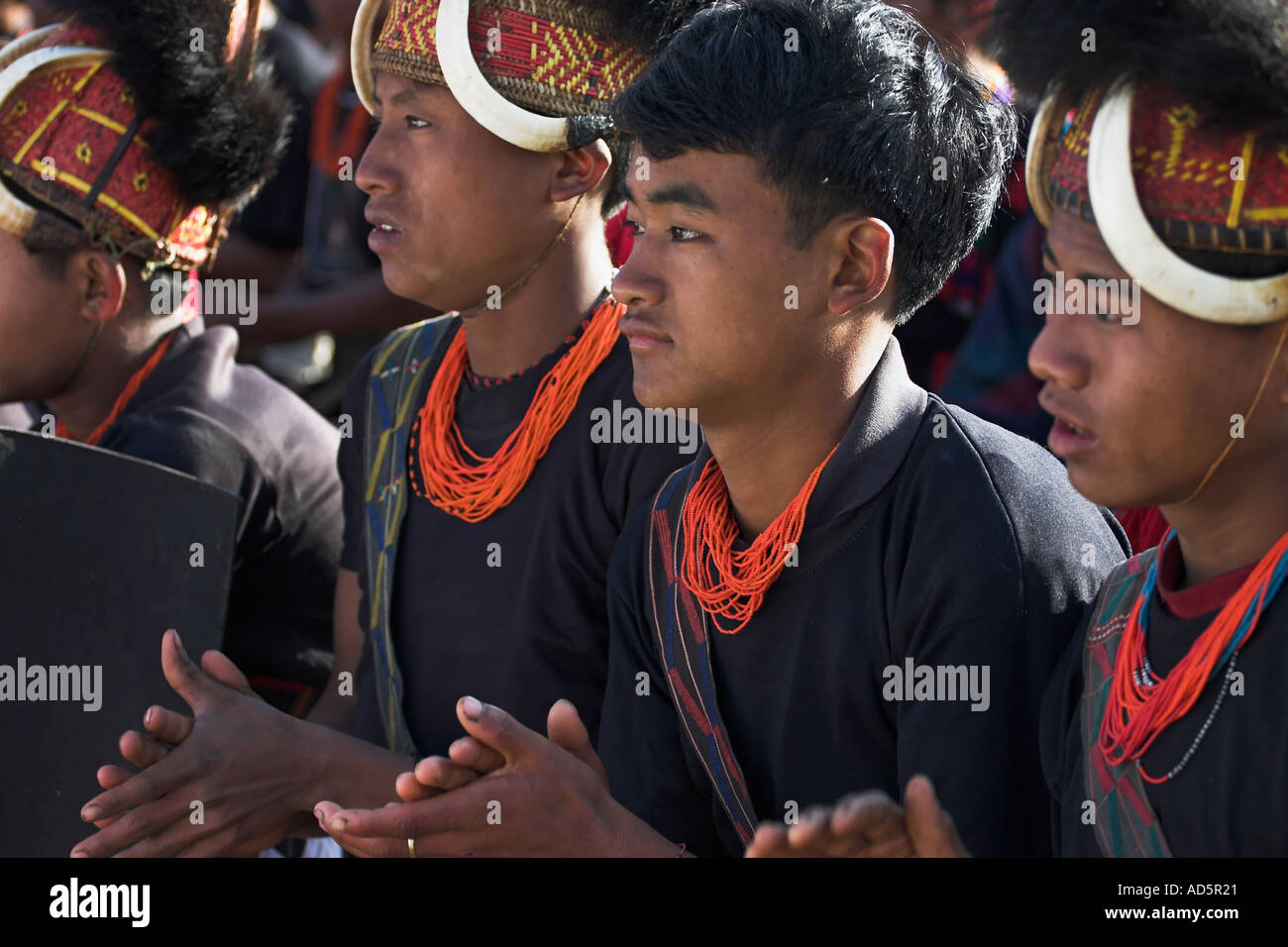 MYANMAR BURMA Naga tribes sitting on bench seating whilst dignitaries ...
