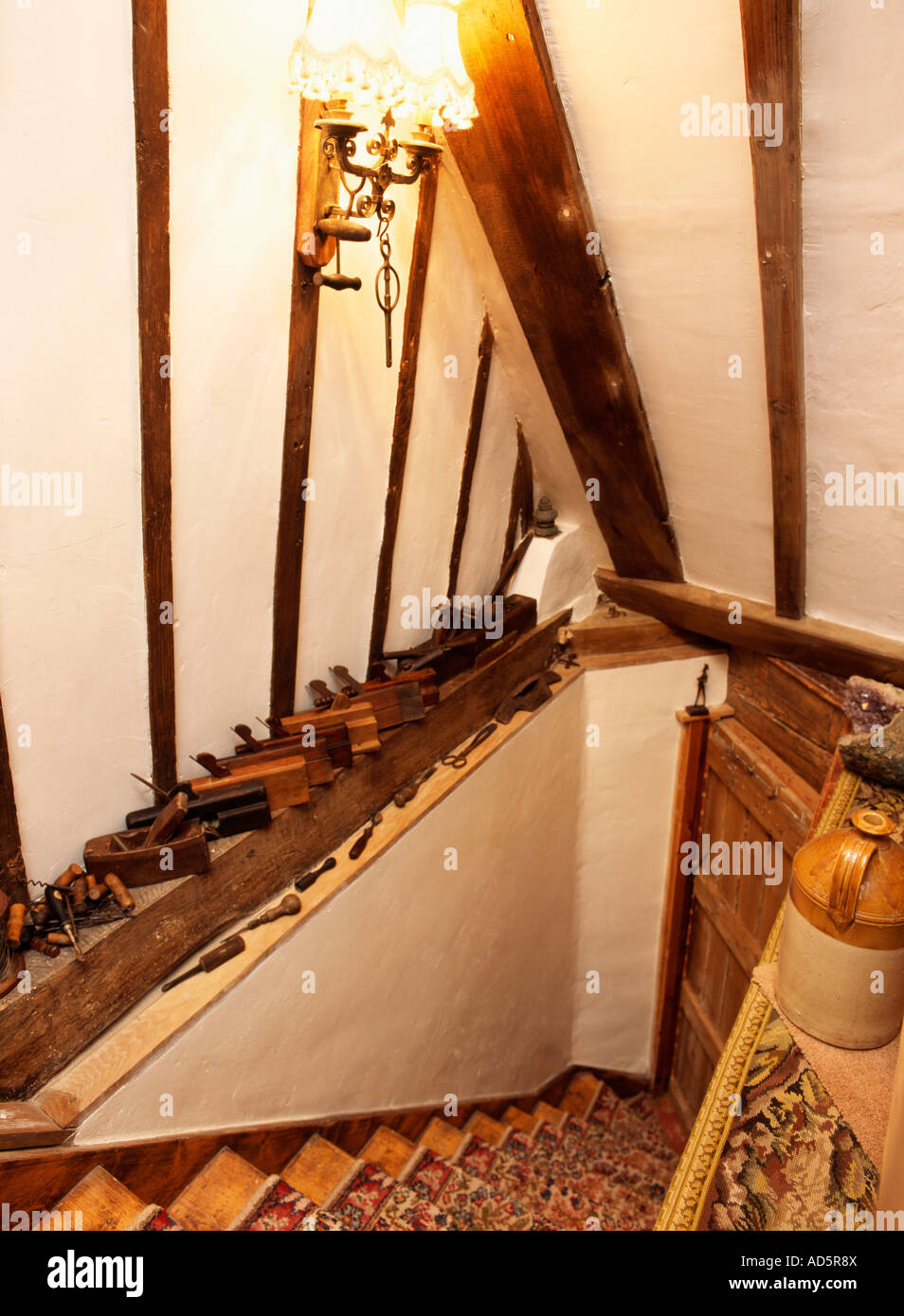 Collection of antique carpenters planing tools above staircase in ...