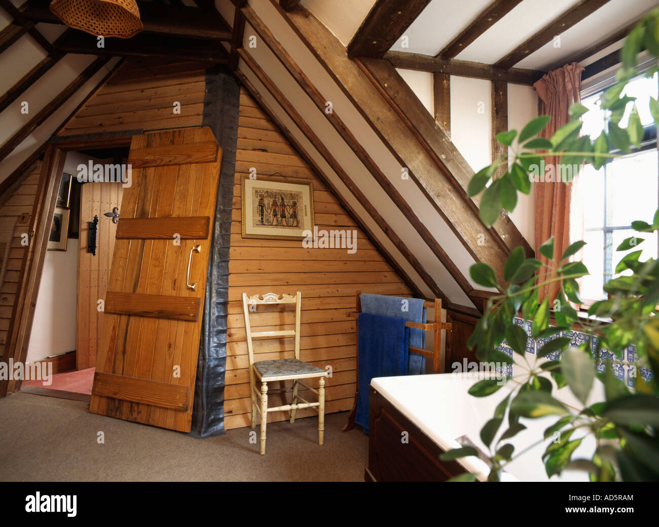 Bathroom with wood panelled walls in converted windmill Stock Photo - Alamy