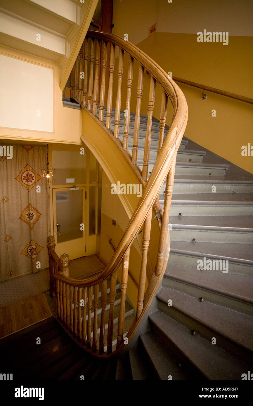 sweeping wooden staircase with landing Stock Photo - Alamy