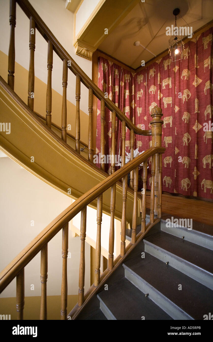 sweeping wooden staircase with landing Stock Photo - Alamy