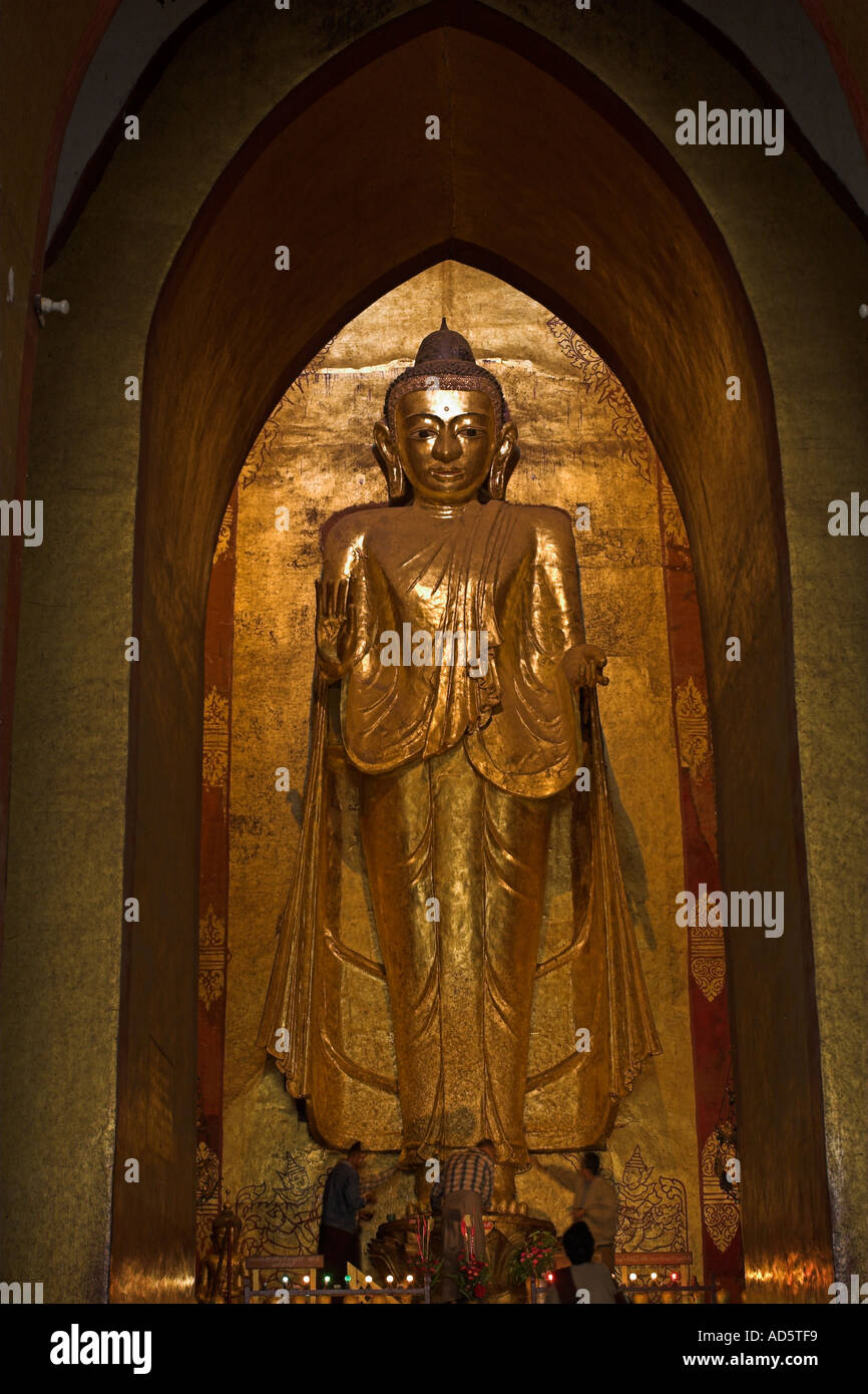 Myanmar Bagan Pilgrims put gold leaf on Standing Buddha the body is ...