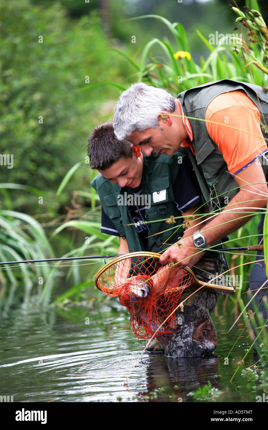 Boy catching a fish hi-res stock photography and images - Alamy