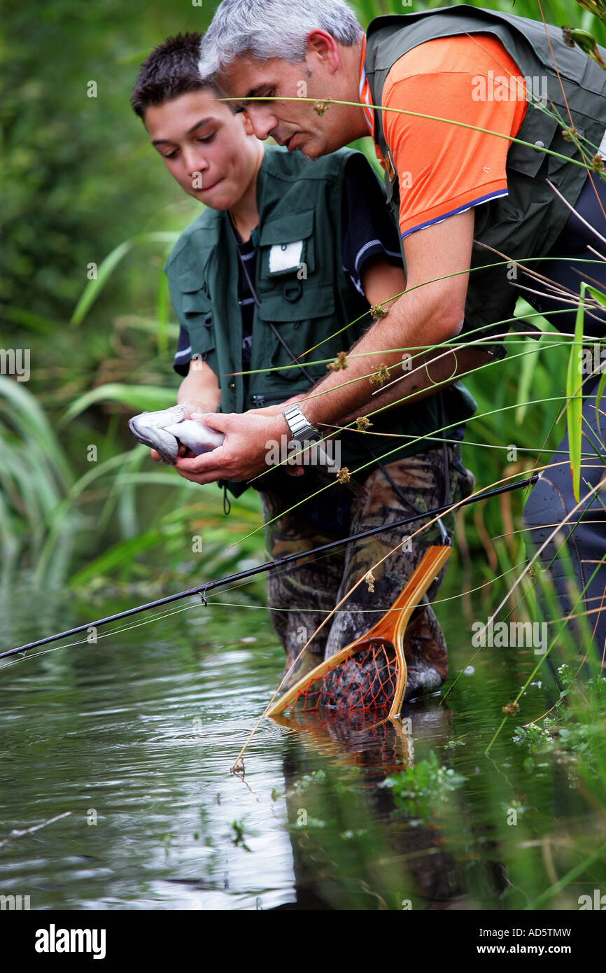 Boy catching a fish hi-res stock photography and images - Alamy