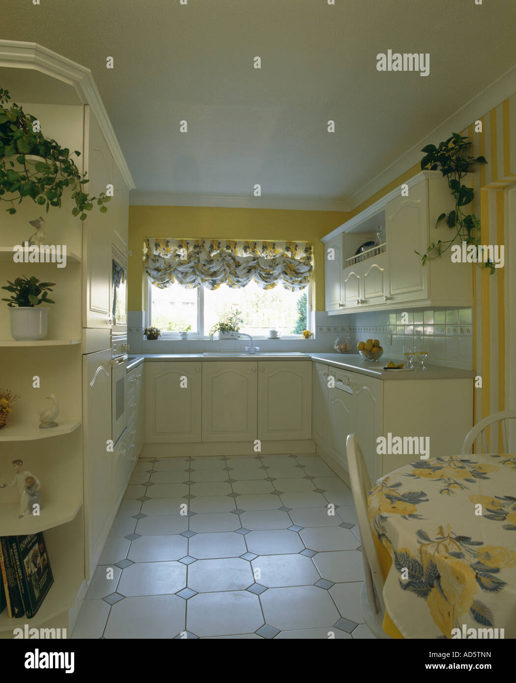 Pastel yellow kitchen diningroom with white tiled floor and floral ...