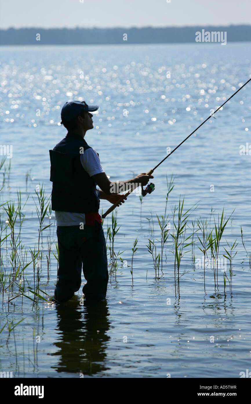 Young man fishing Stock Photo - Alamy