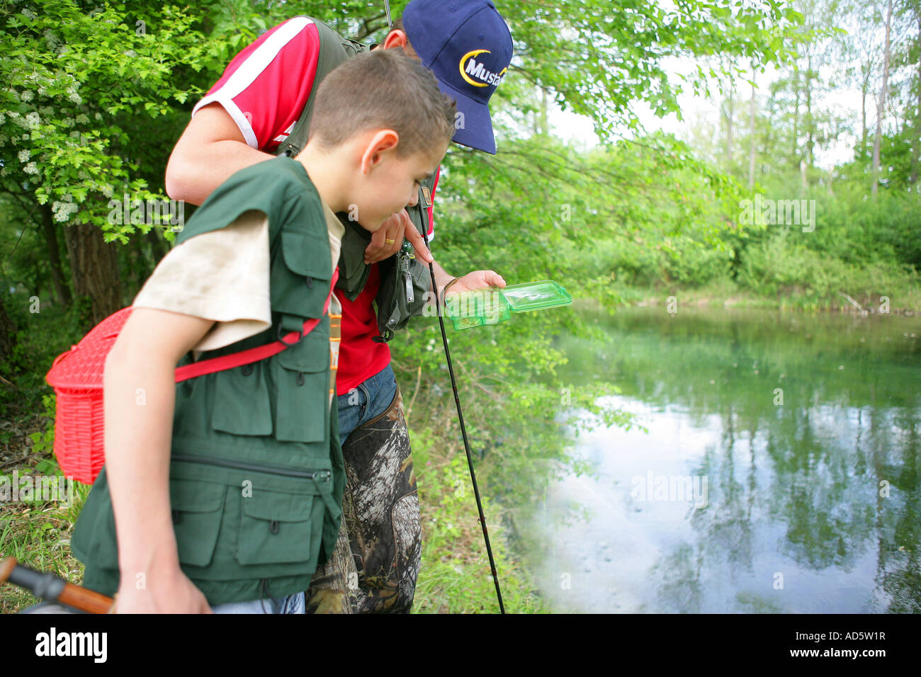 Man and boy choosing the bait Stock Photo - Alamy