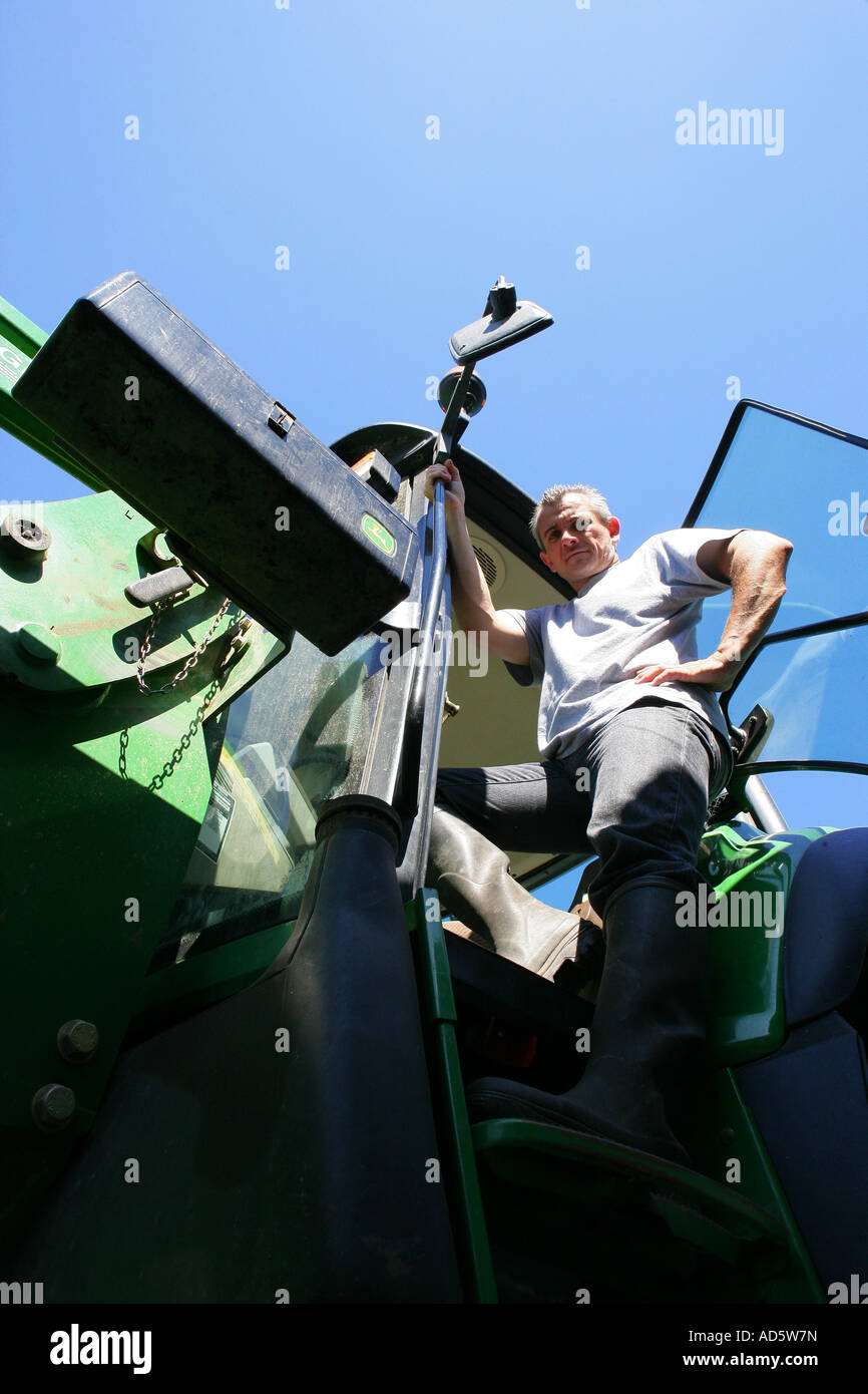 Farmer using a farm machine Stock Photo - Alamy