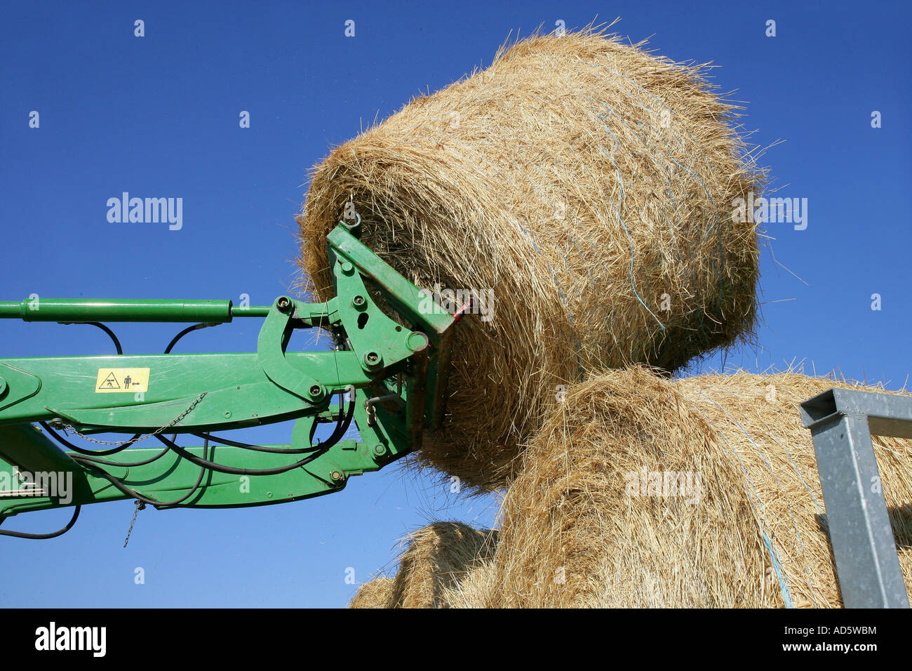 Farm machine carrying dry hay rolls Stock Photo - Alamy