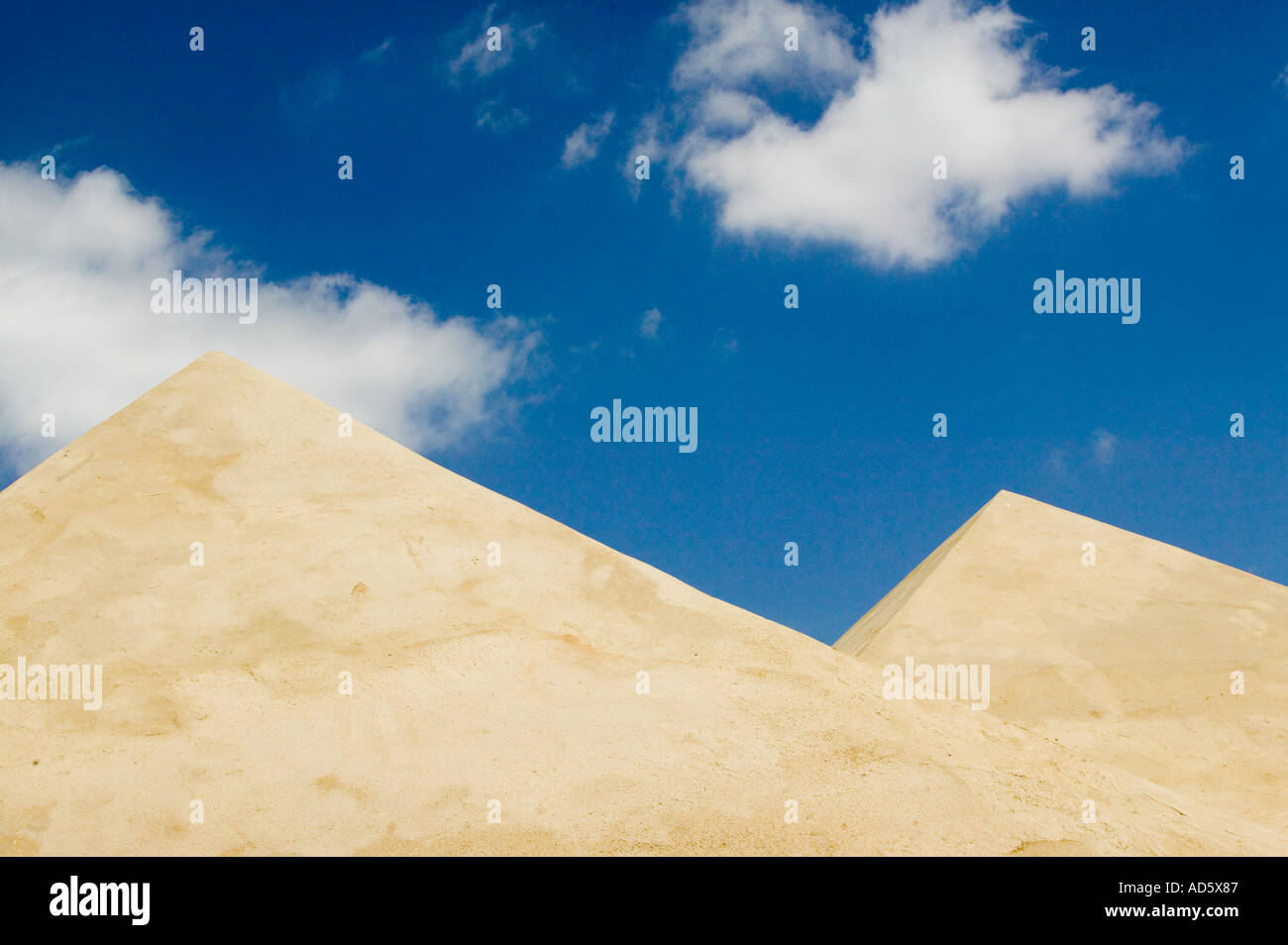 Two sand pyramids against a blue sky Black Rock Brighton, England UK ...