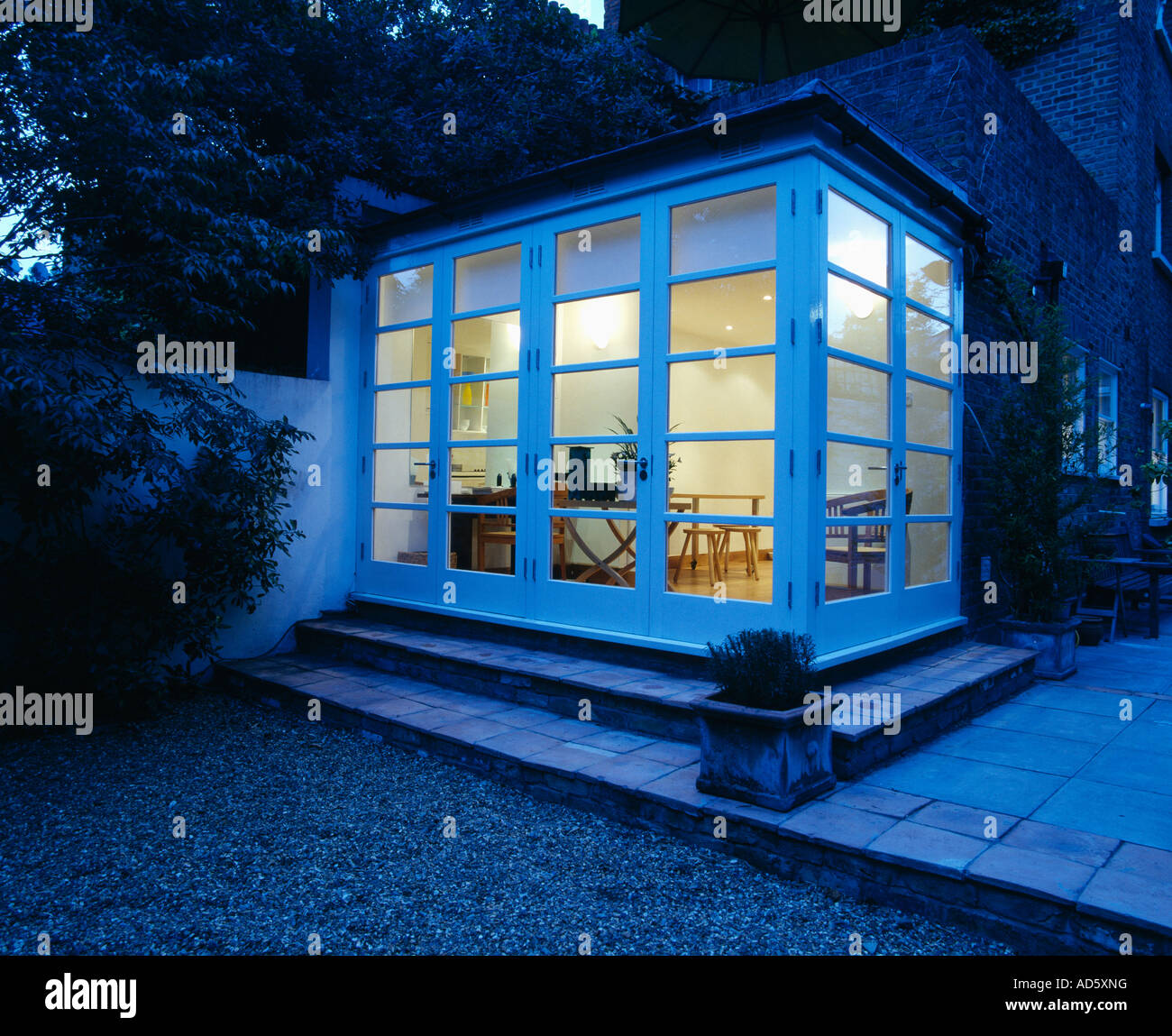 View from outside through windows of modern conservatory extension at ...