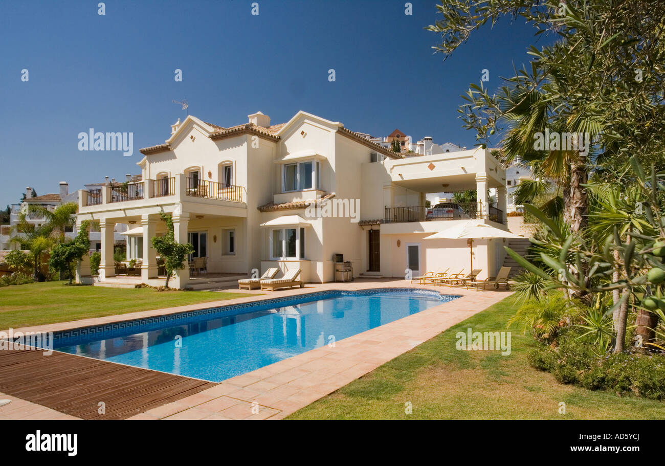 Large white Spanish villa with veranda and turquoise swimmingpool Stock ...