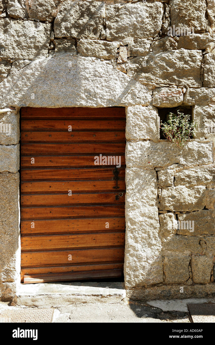 Entrance door into a rough stones building Stock Photo - Alamy