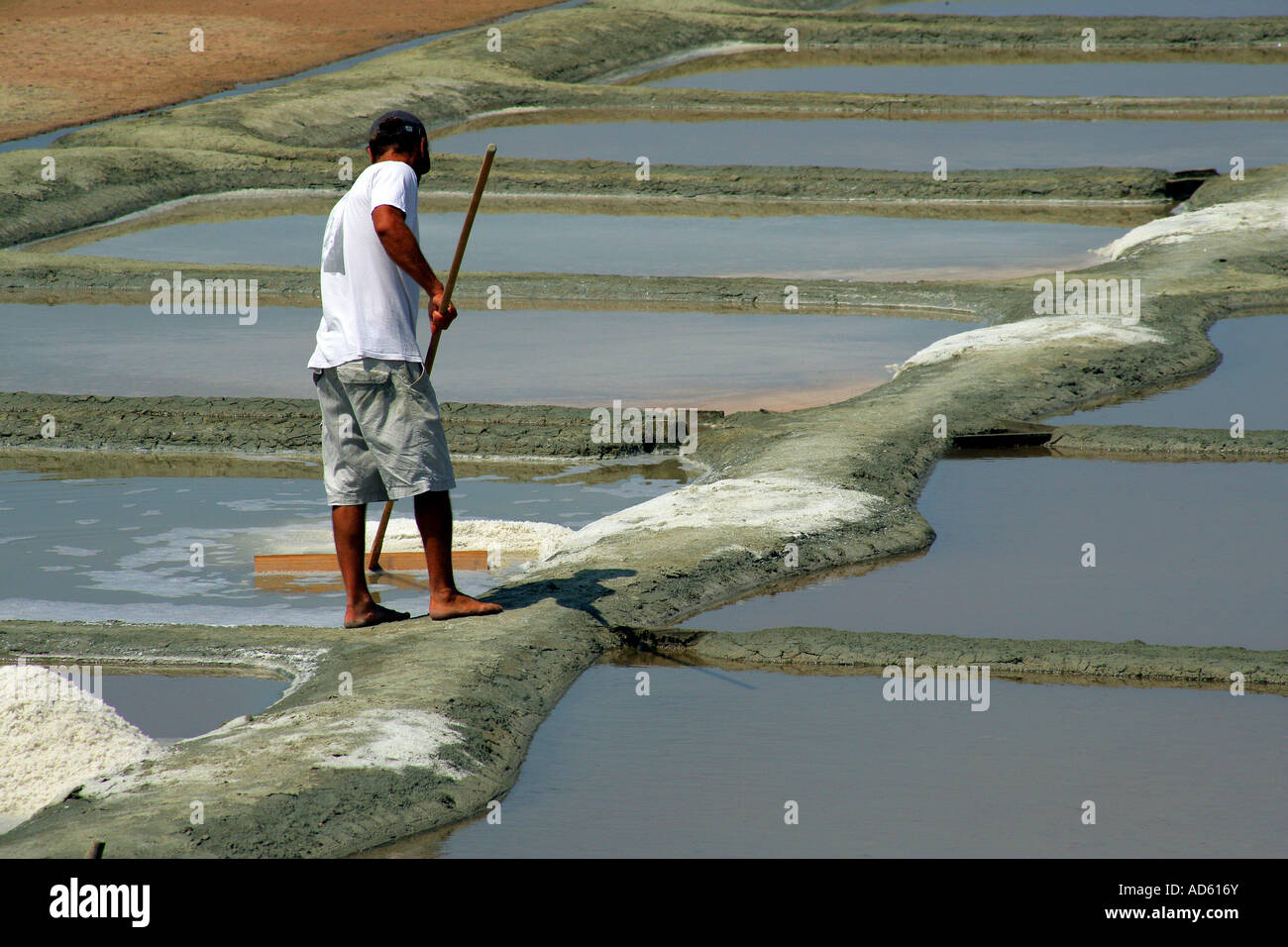 Man working on salty sea water basins Stock Photo - Alamy