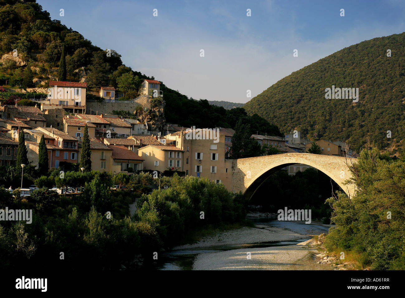 Village with bridge by a river Stock Photo - Alamy