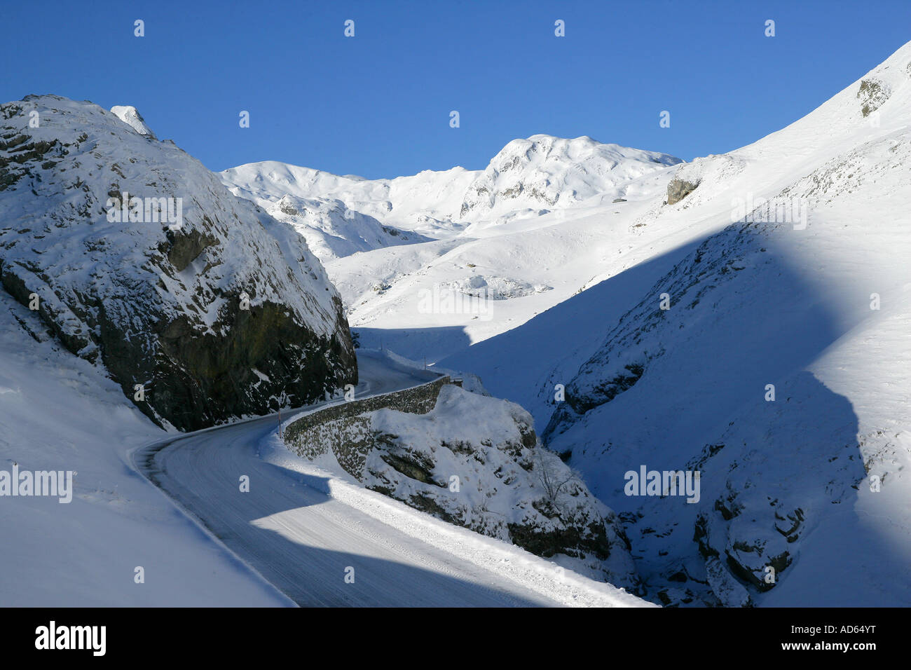 snow covered road, in the heart of a snow covered mountain massif, a ...