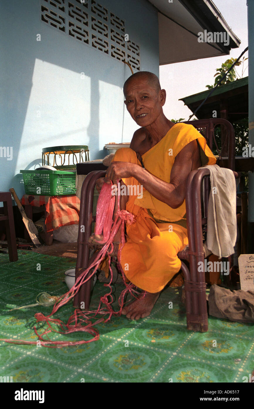 Laos Old monk doing his chores within his monastry on the Thai border ...