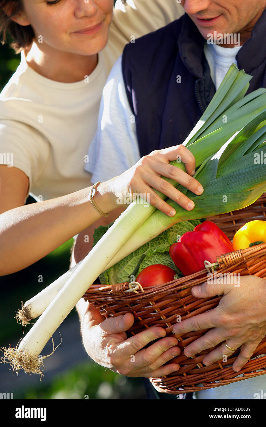 young man and woman holding a leek Stock Photo - Alamy