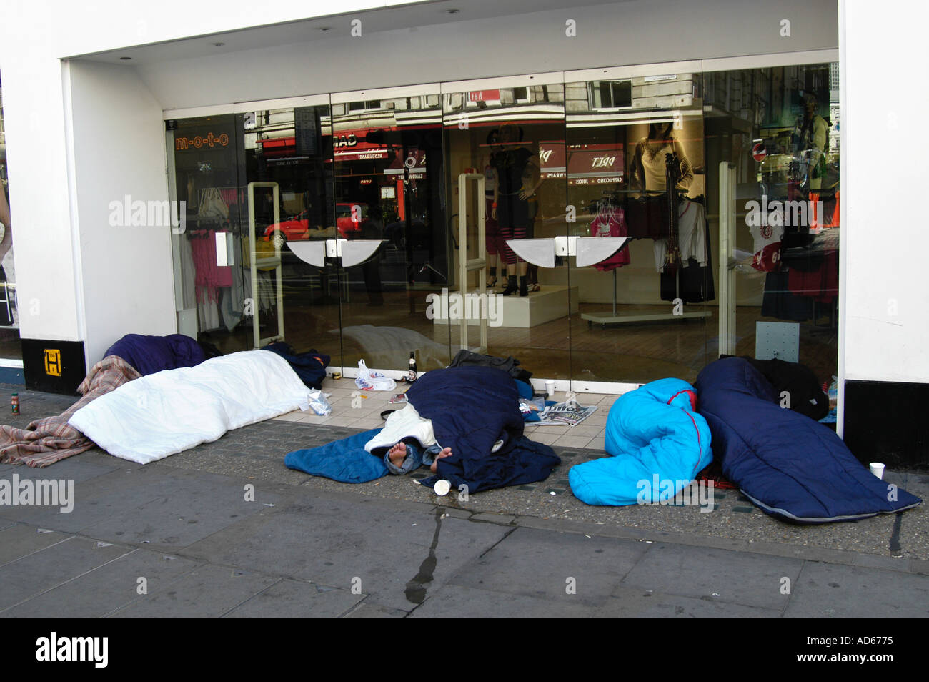 Homeless people sleeping rough in shop doorway on the Strand, London ...