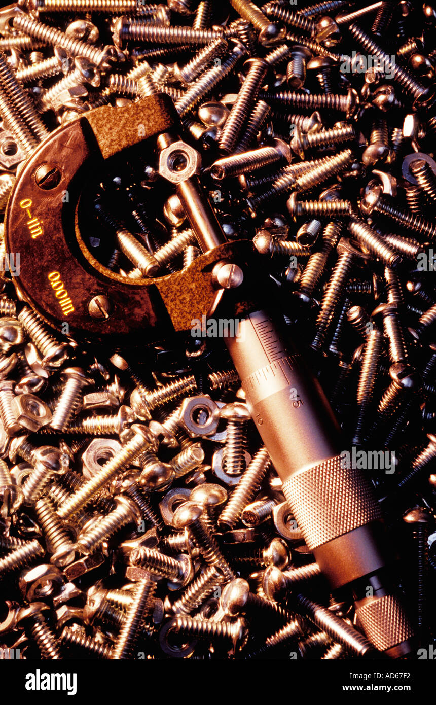 Micrometer measuring a nut on background of nut and bolts Stock Photo ...