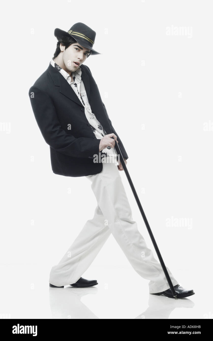 Side profile of a young man posing with a cane Stock Photo - Alamy