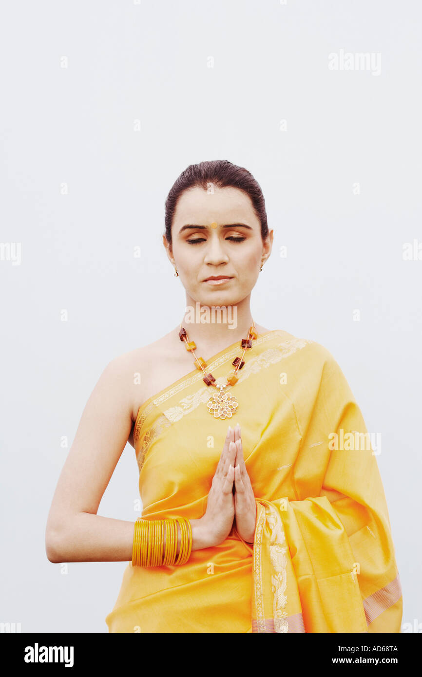 Close-up of a young woman standing in a prayer position Stock Photo - Alamy