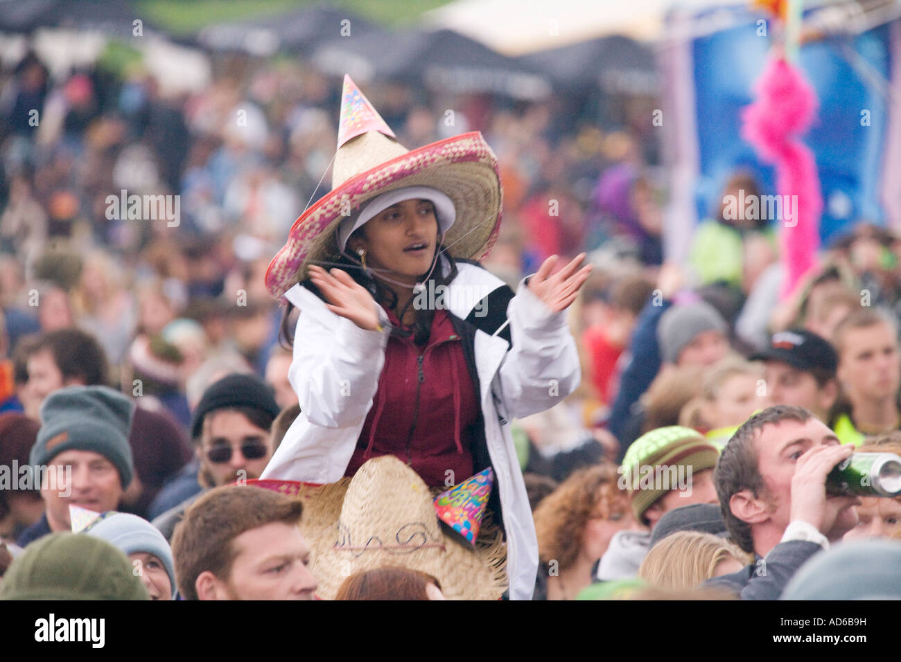 Photographs of the music fans crowd girl hat near the stage at the ...