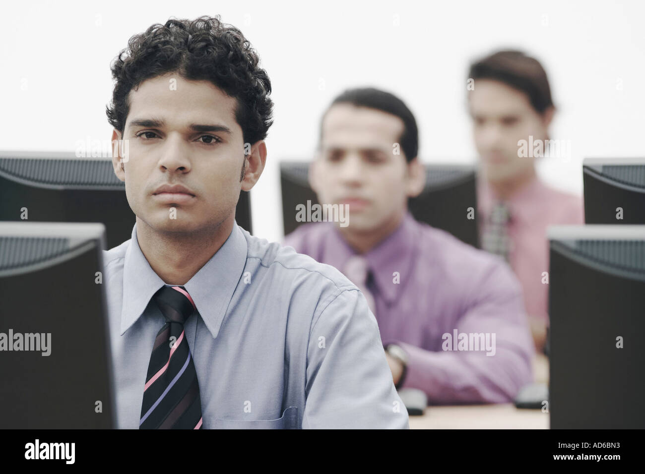 Businessmen working on computers in an office Stock Photo - Alamy