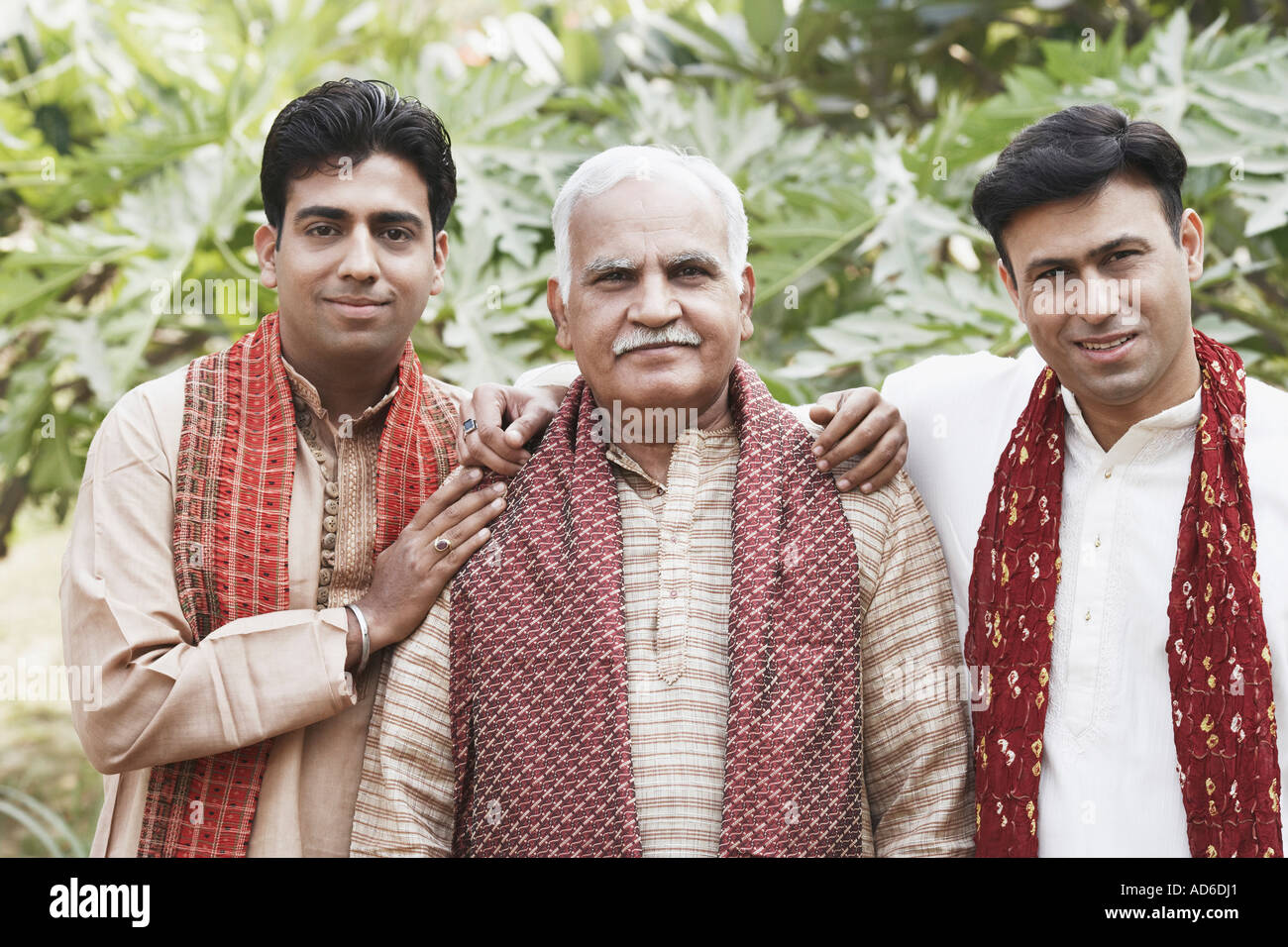 Portrait of a father and his two sons smiling Stock Photo - Alamy