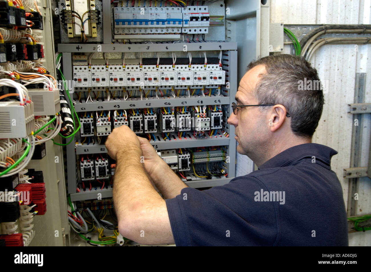 Electrical engineer working on electrical panel Stock Photo - Alamy