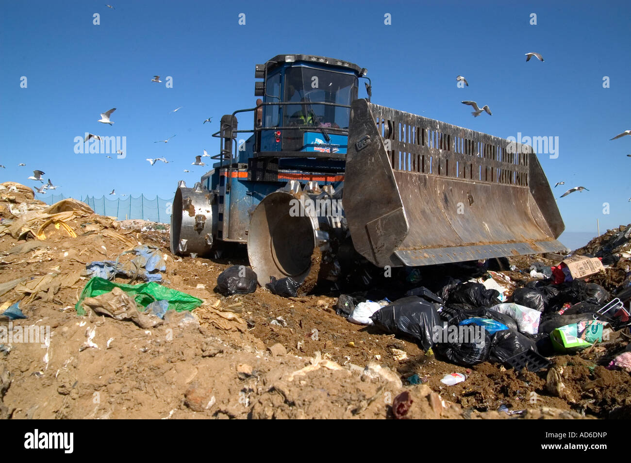 Machine working on landfill site UK Stock Photo - Alamy