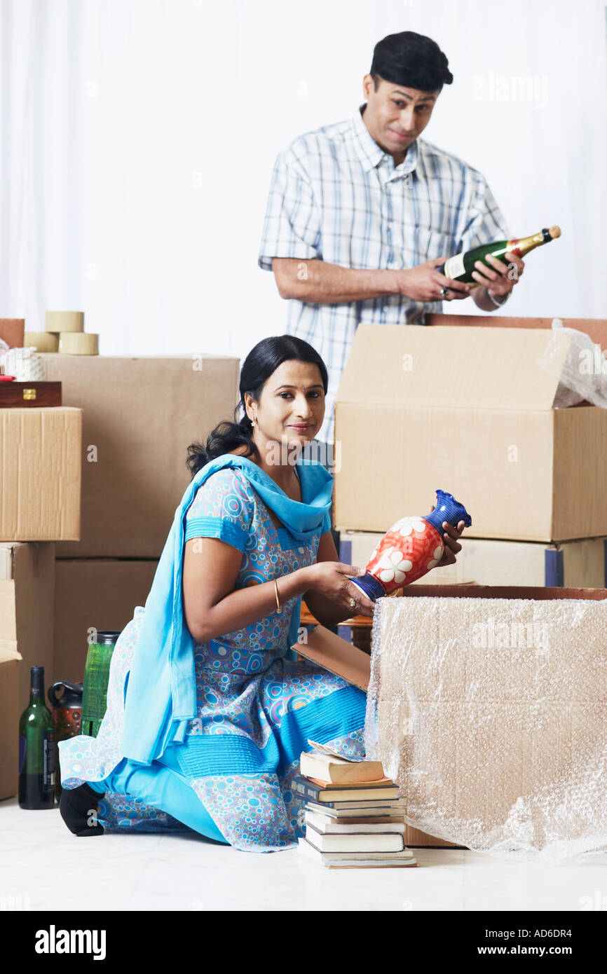 Mid adult couple unpacking cardboard boxes Stock Photo - Alamy
