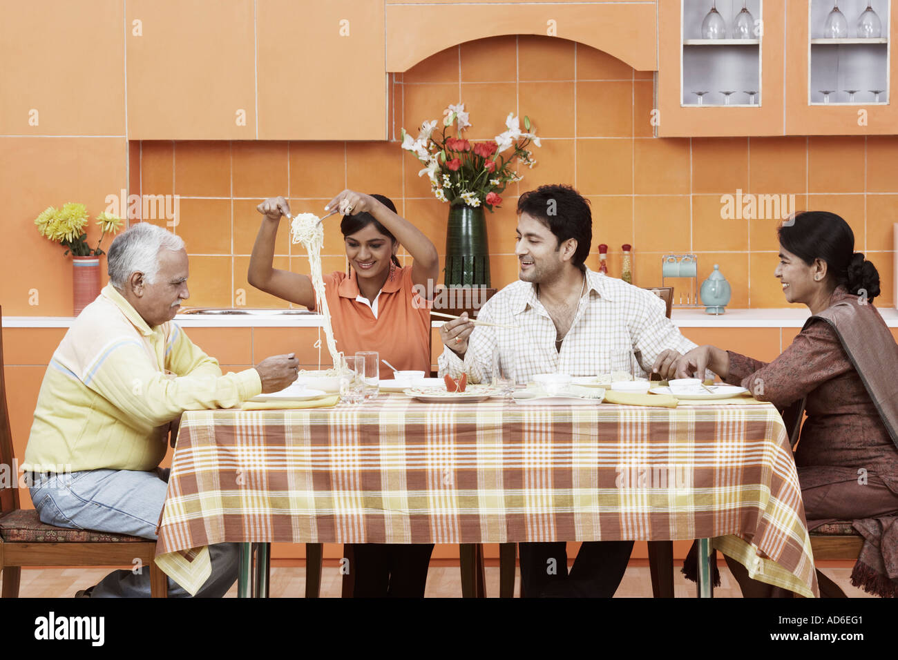 Side profile of a mature couple and their two children at the dining ...