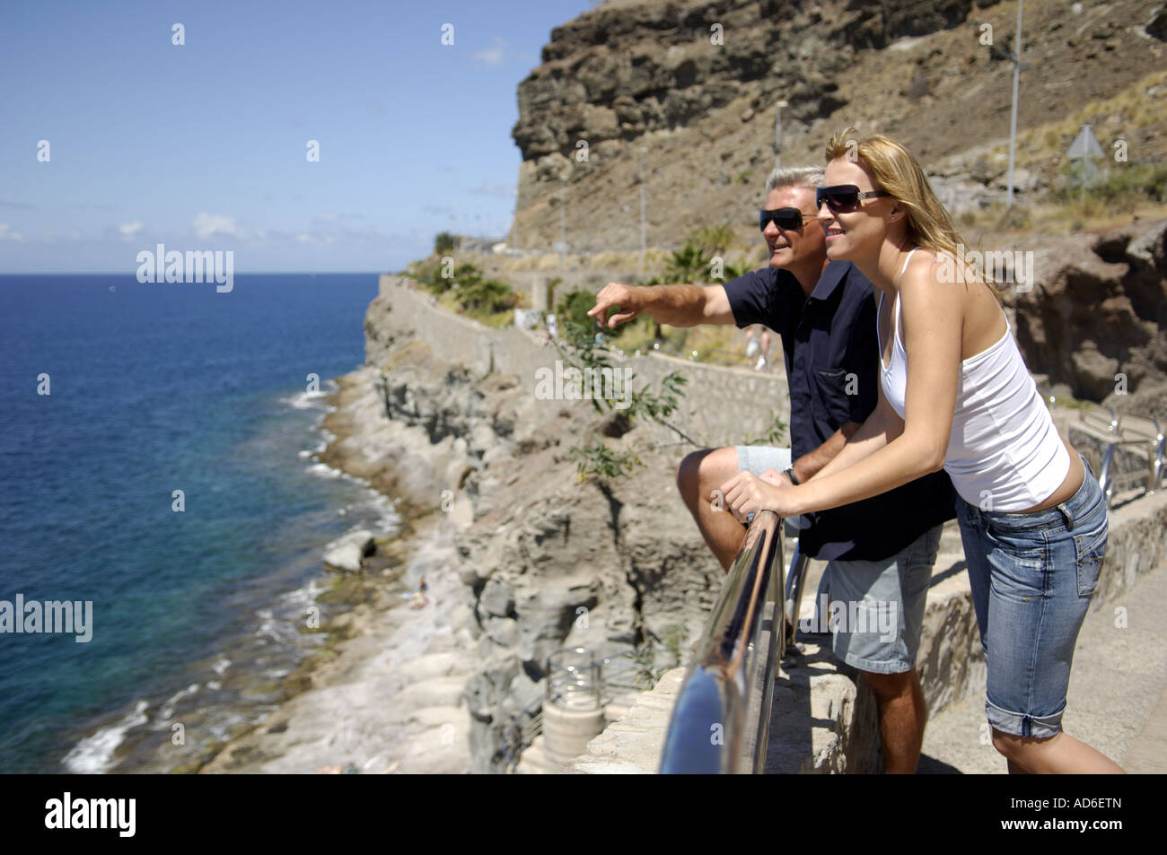 Couple take in view from cliffs - Puerto Rico Gran Canaria Stock Photo ...