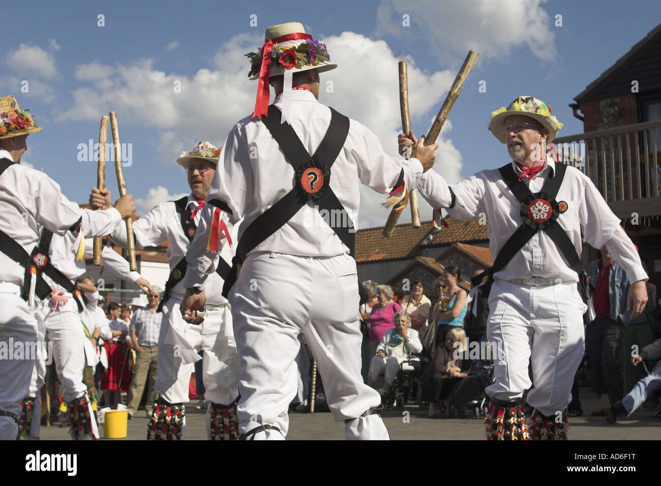 Morris dancers with floral hats performing a stick dance UK summer ...