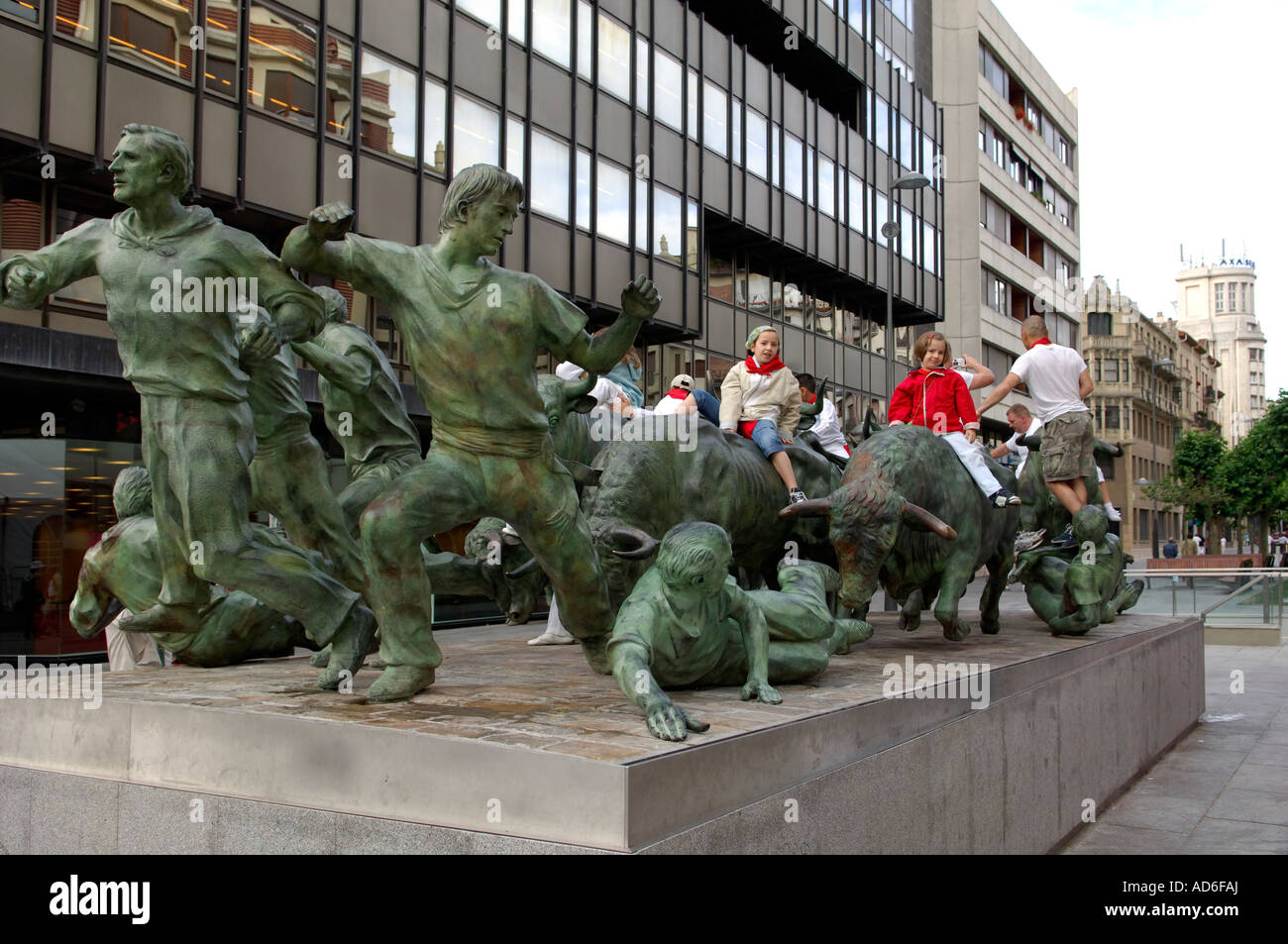 Tourists pose for photograph on bull run statue - Pamplona Spain Stock ...