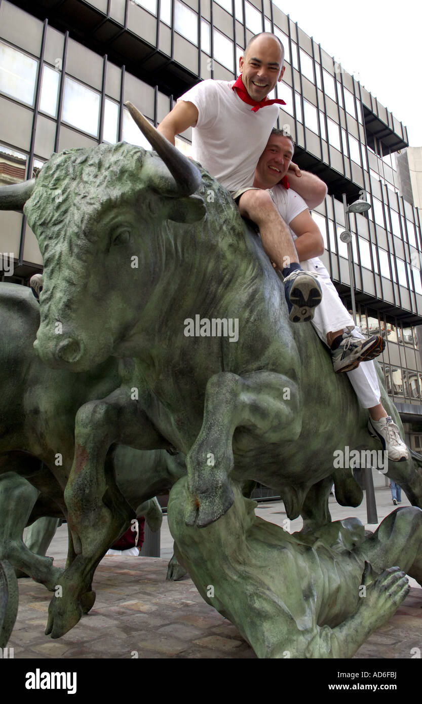 Tourists pose for photograph on bull run statue - Pamplona Spain Stock ...
