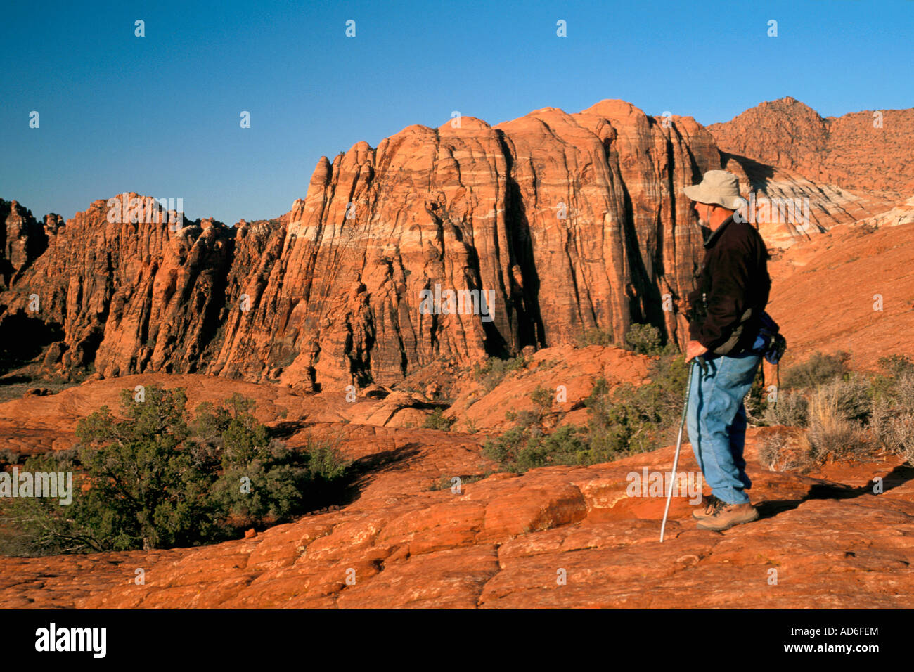 Hiker on slickrock above Snow Canyon Snow Canyon State Park Ivins Utah ...