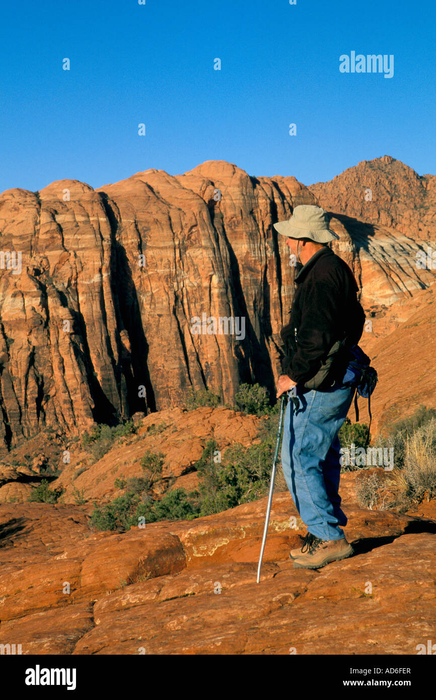 Hiker on slickrock above Snow Canyon Snow Canyon State Park Ivins Utah ...