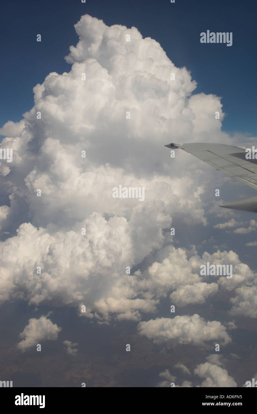 Vietnam huge cloud seen from inside a plane with aircraft wing in frgd ...