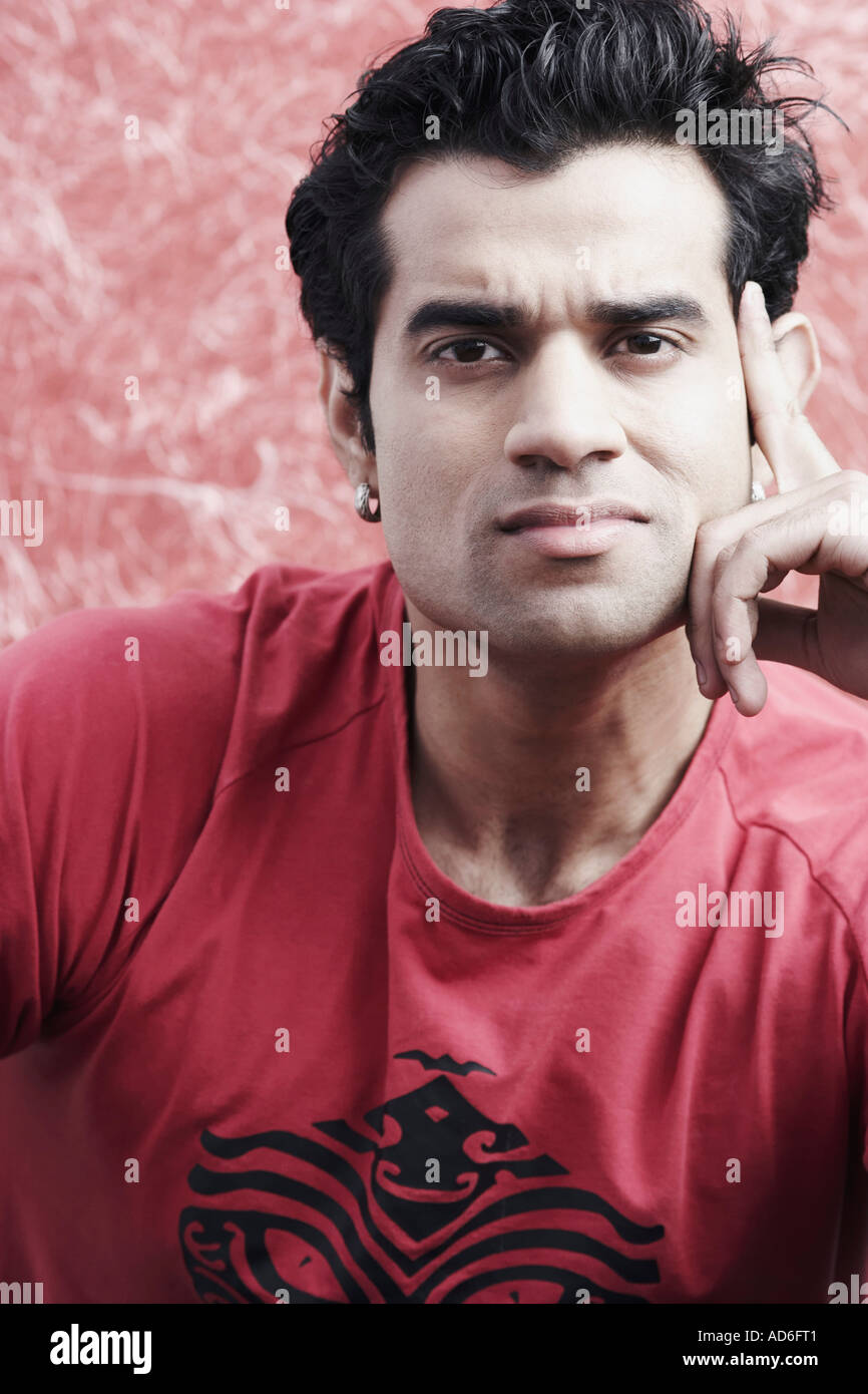 Portrait of a young man thinking Stock Photo - Alamy